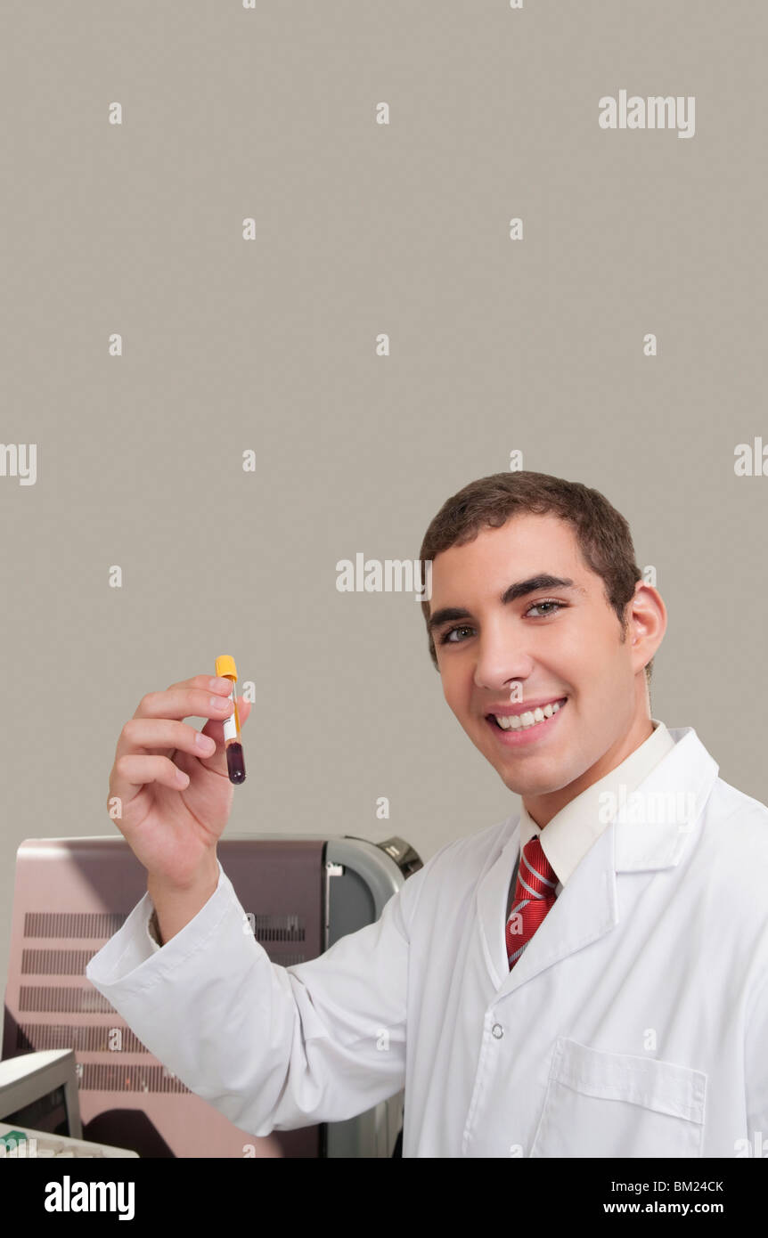 Lab technician holding a blood sample in a test tube Stock Photo - Alamy