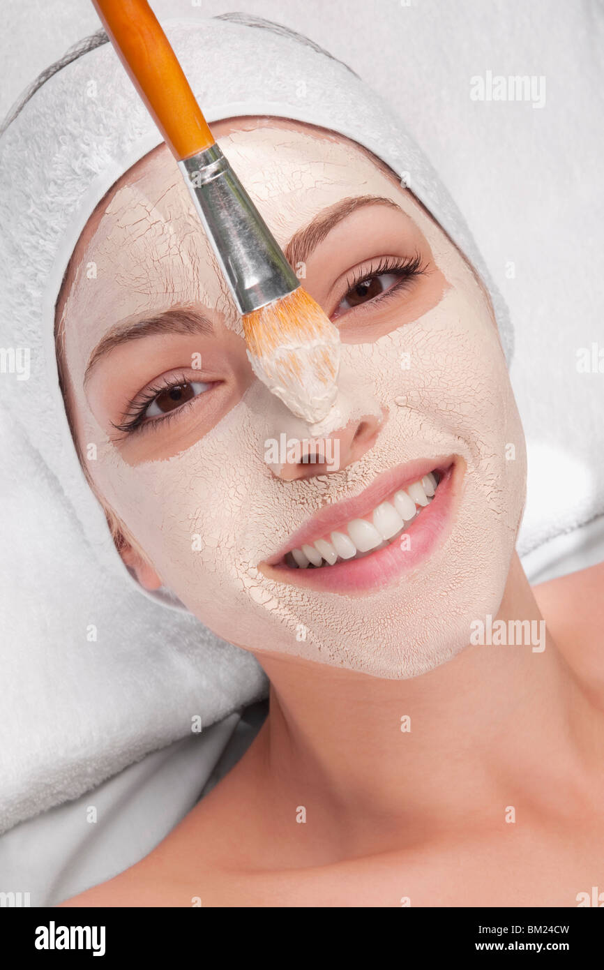 Woman applying face pack Stock Photo - Alamy