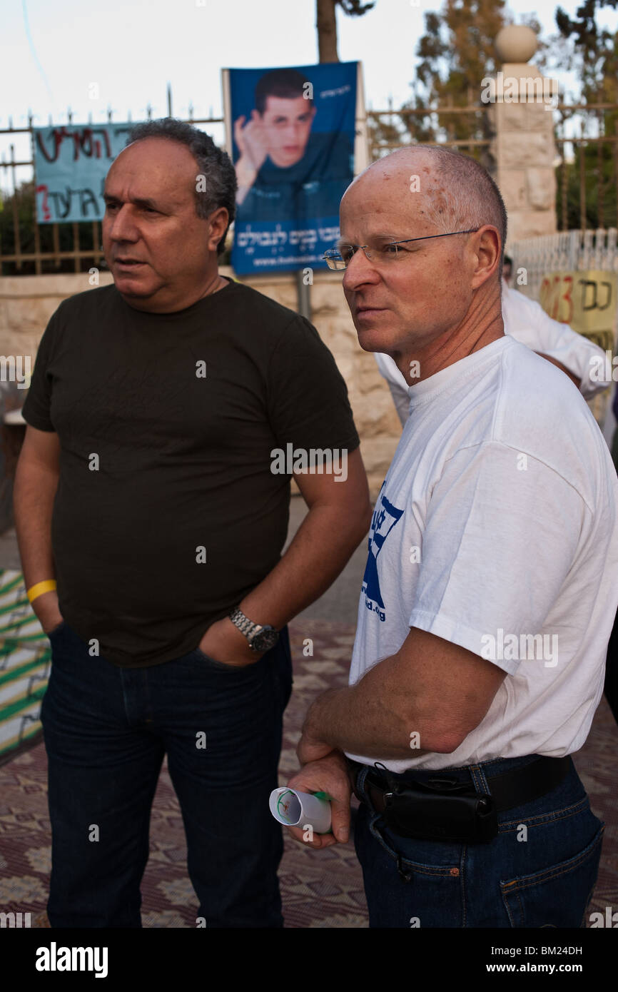 Father Noam Shalit with redeemed POW Chezi Shai at a Sabbath welcoming ...