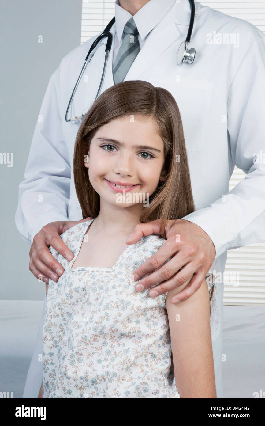 Doctor standing with a girl Stock Photo - Alamy