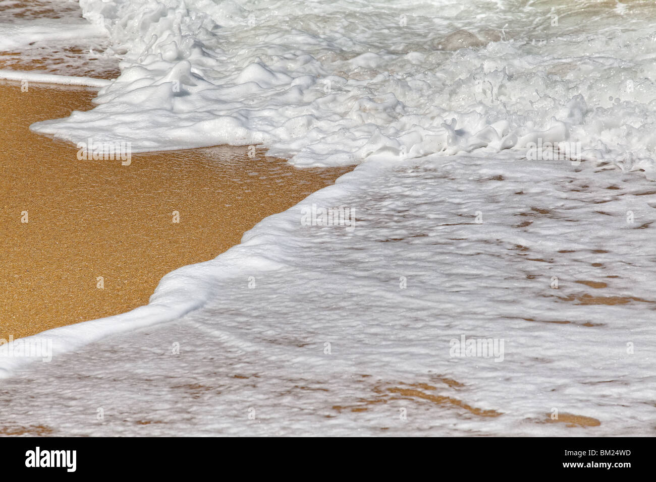 Background image of foam and waves on a sandy beach Stock Photo - Alamy
