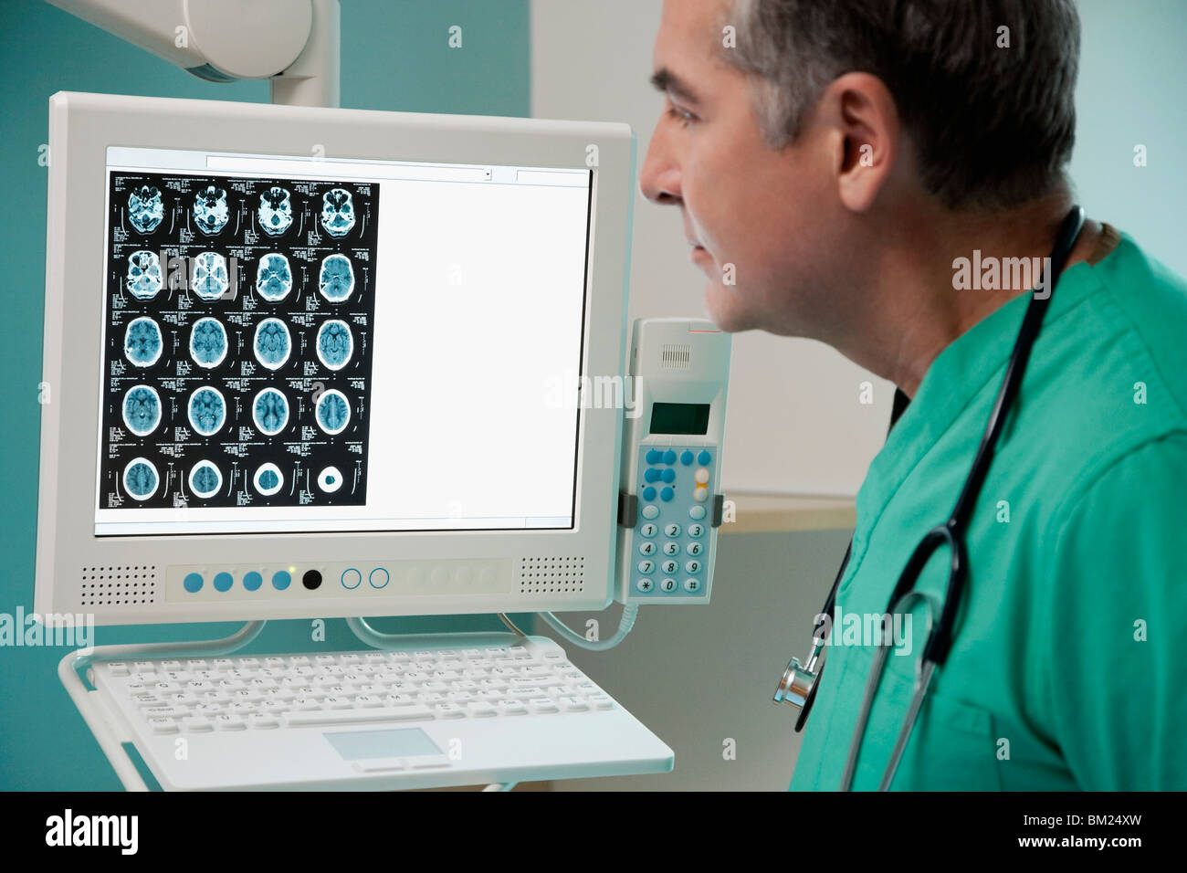 Doctor examining MRI report on computer screen Stock Photo - Alamy