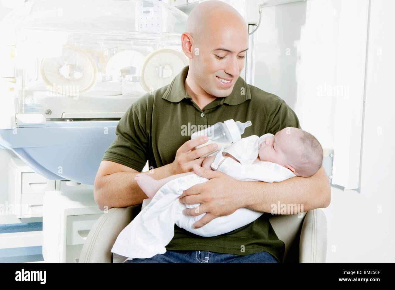 Man carrying his newborn baby Stock Photo - Alamy