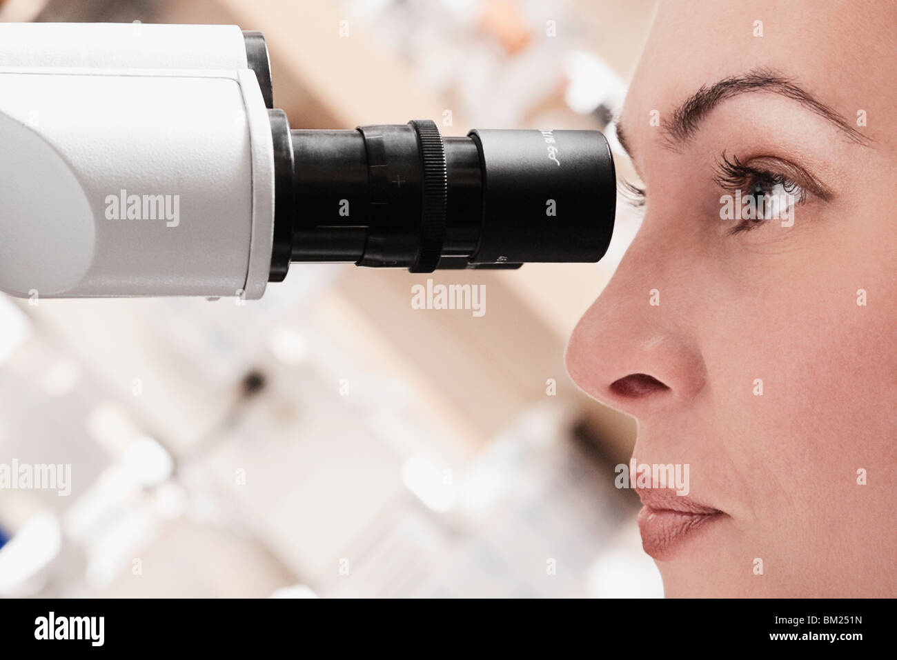 Female doctor working on a microscope in a laboratory Stock Photo - Alamy