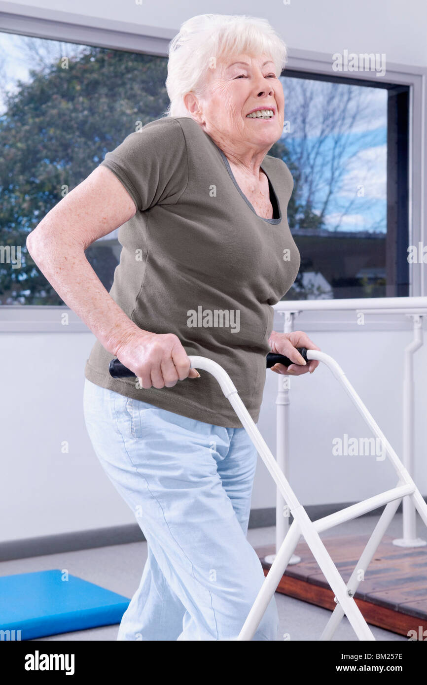 Close-up of a disabled woman walking with a walker Stock Photo - Alamy