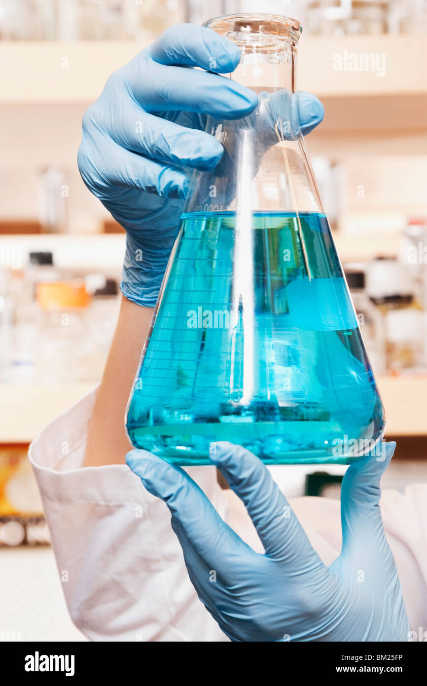 Female doctor holding a conical flask in a laboratory Stock Photo - Alamy