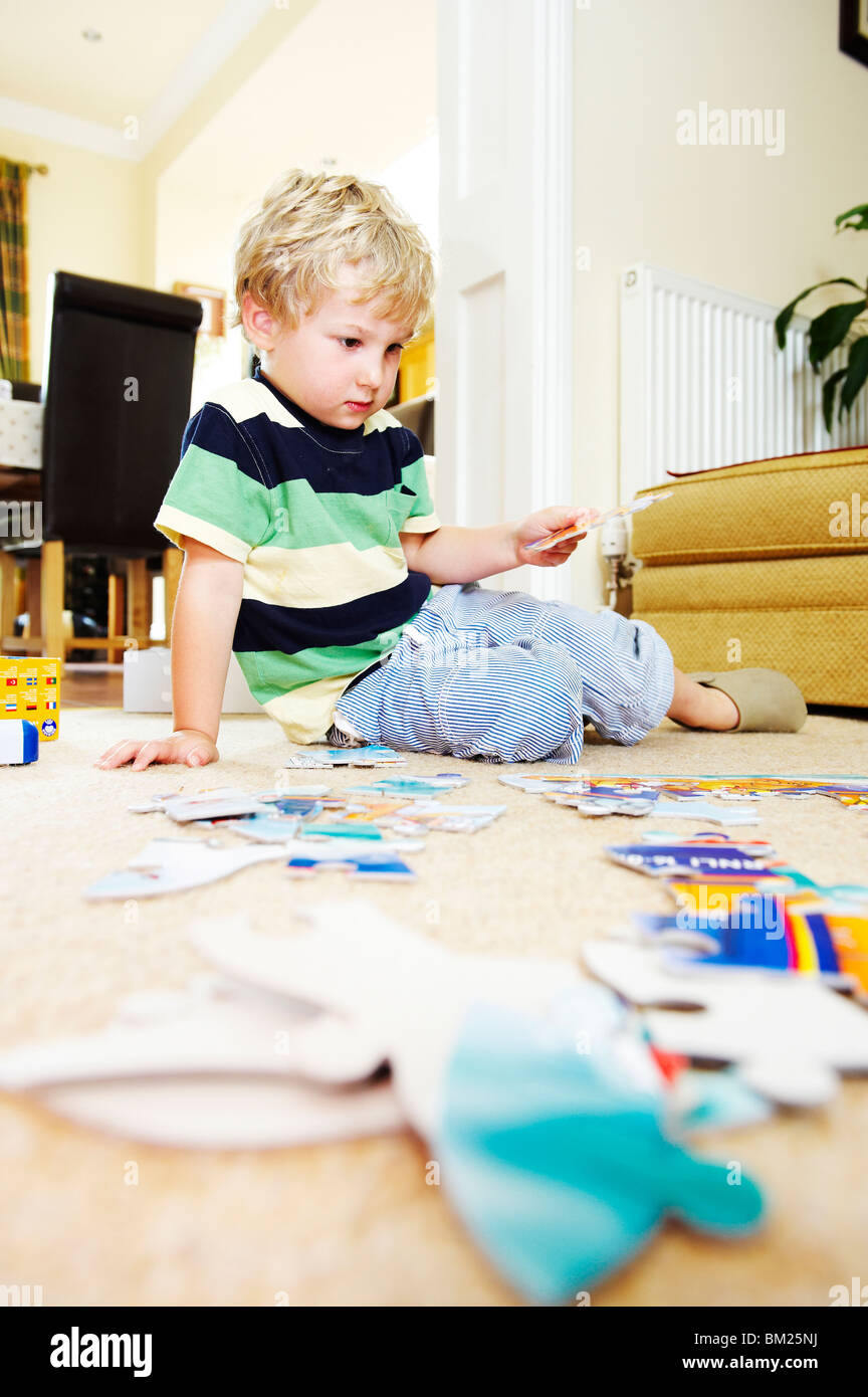 Boy playing with jigsaw puzzle Stock Photo - Alamy