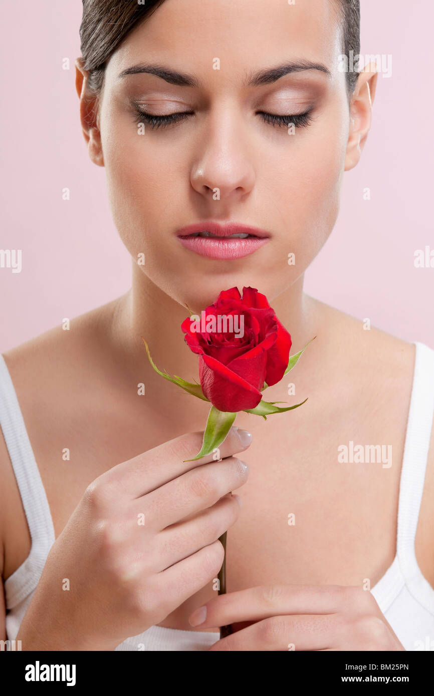 Close-up of a woman smelling a rose Stock Photo - Alamy