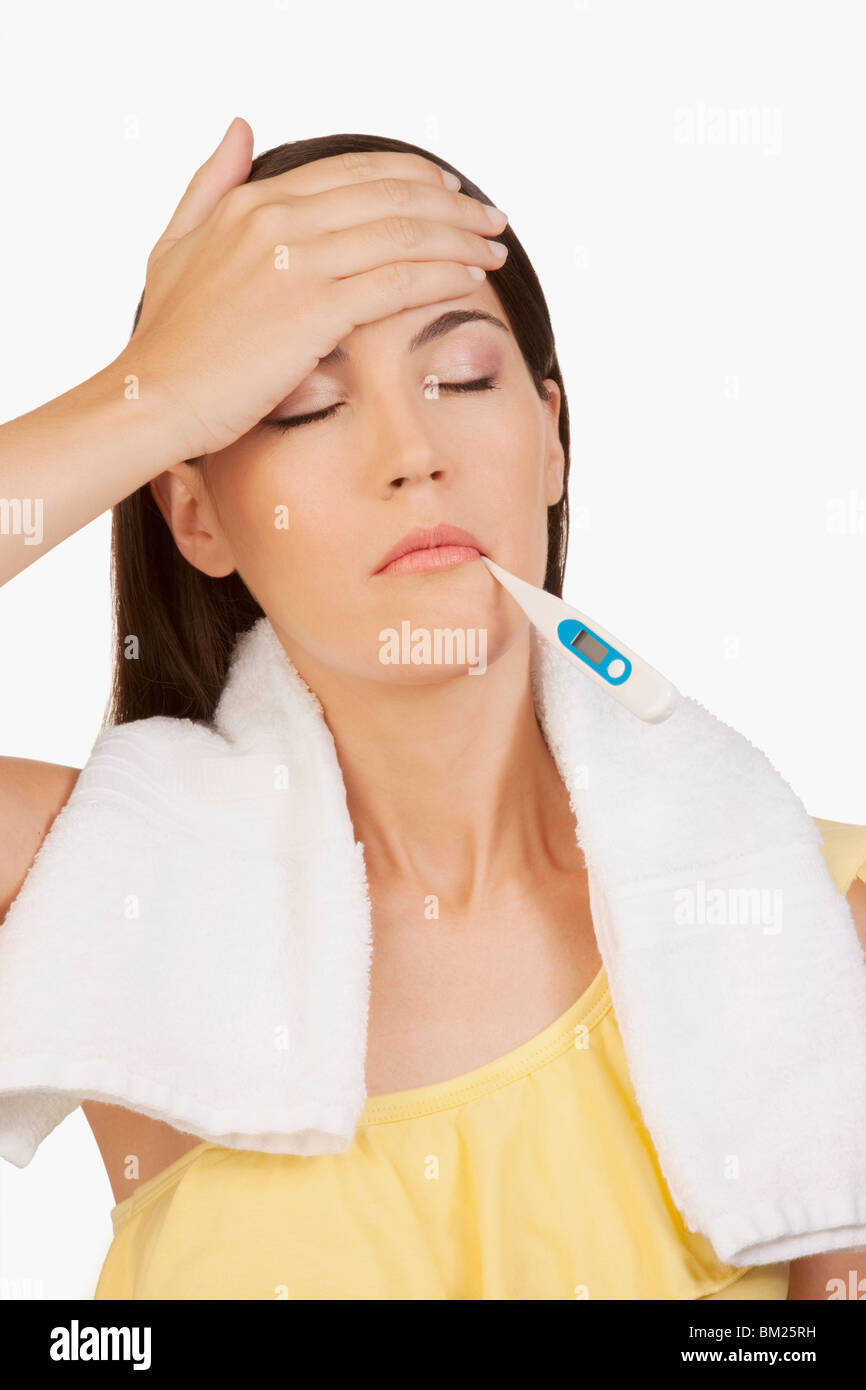 Woman taking her temperature Stock Photo - Alamy