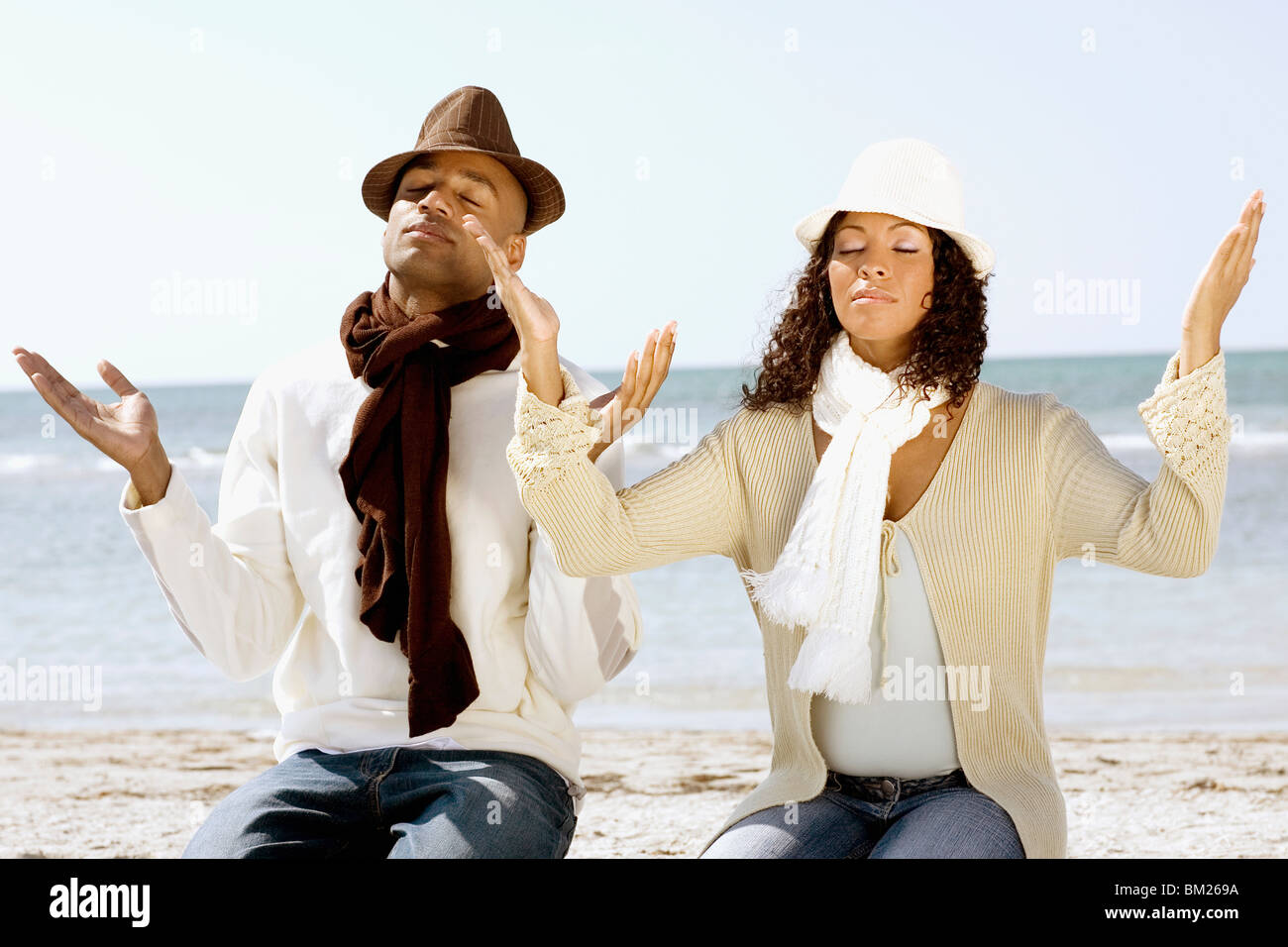Two people meditating on beach hi-res stock photography and images - Alamy