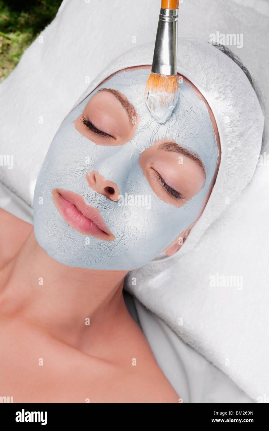 Woman applying face pack Stock Photo - Alamy
