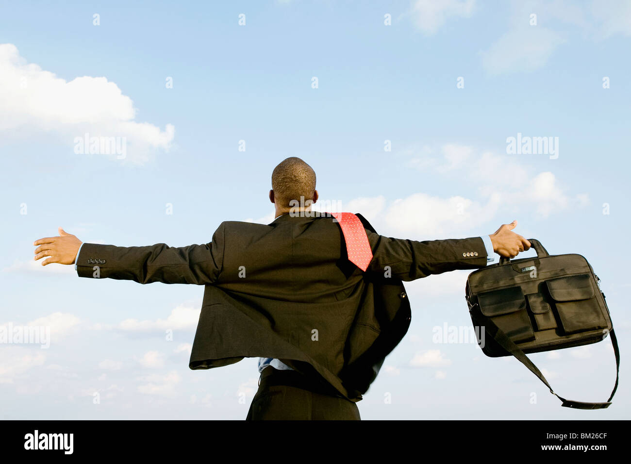 Businessman standing with his arm outstretched Stock Photo - Alamy
