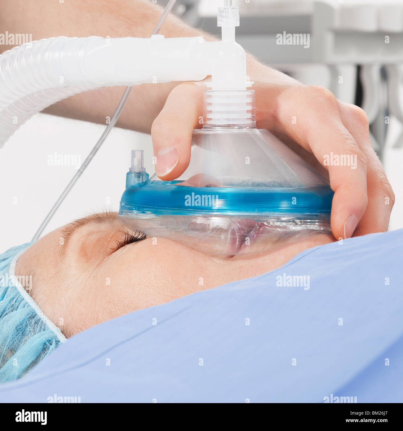 Anesthetist holding oxygen mask over patient's mouth in hospital Stock ...