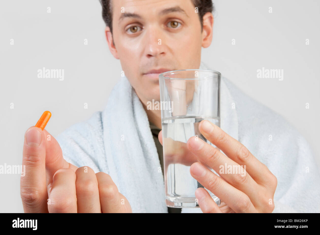 Portrait of a mid adult man taking medicine Stock Photo - Alamy
