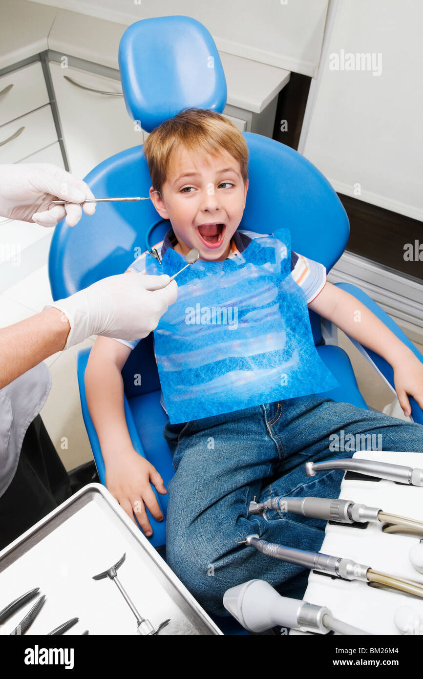 Dentist examining a boy's teeth Stock Photo - Alamy