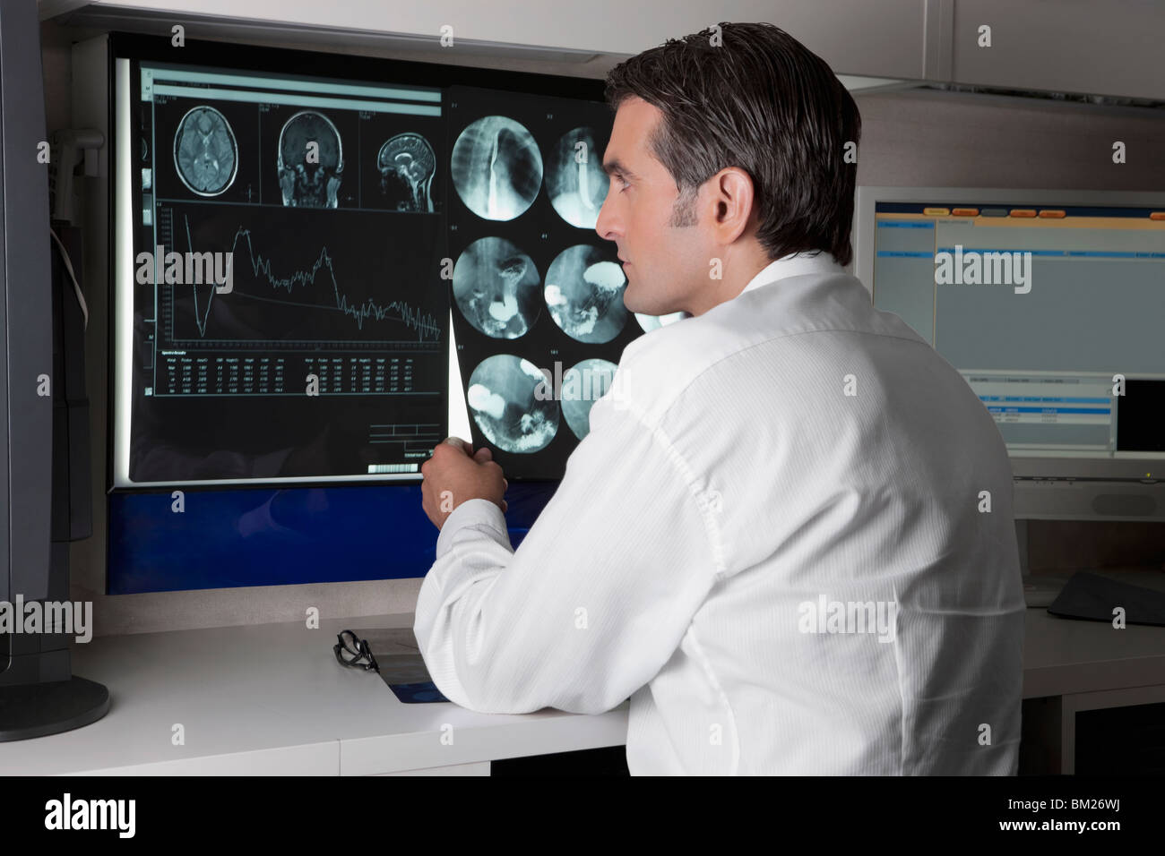 Doctor examining MRI report Stock Photo - Alamy