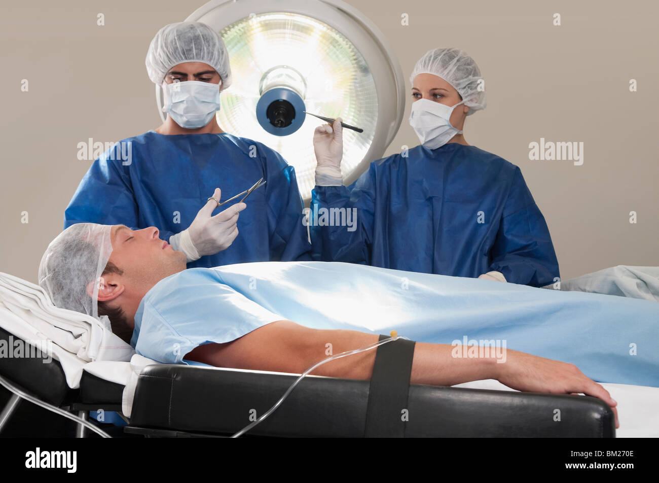 Two surgeons operating a patient in an operating room Stock Photo - Alamy