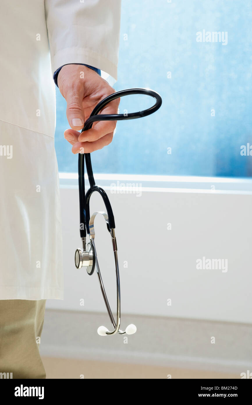 Doctor holding a stethoscope Stock Photo - Alamy