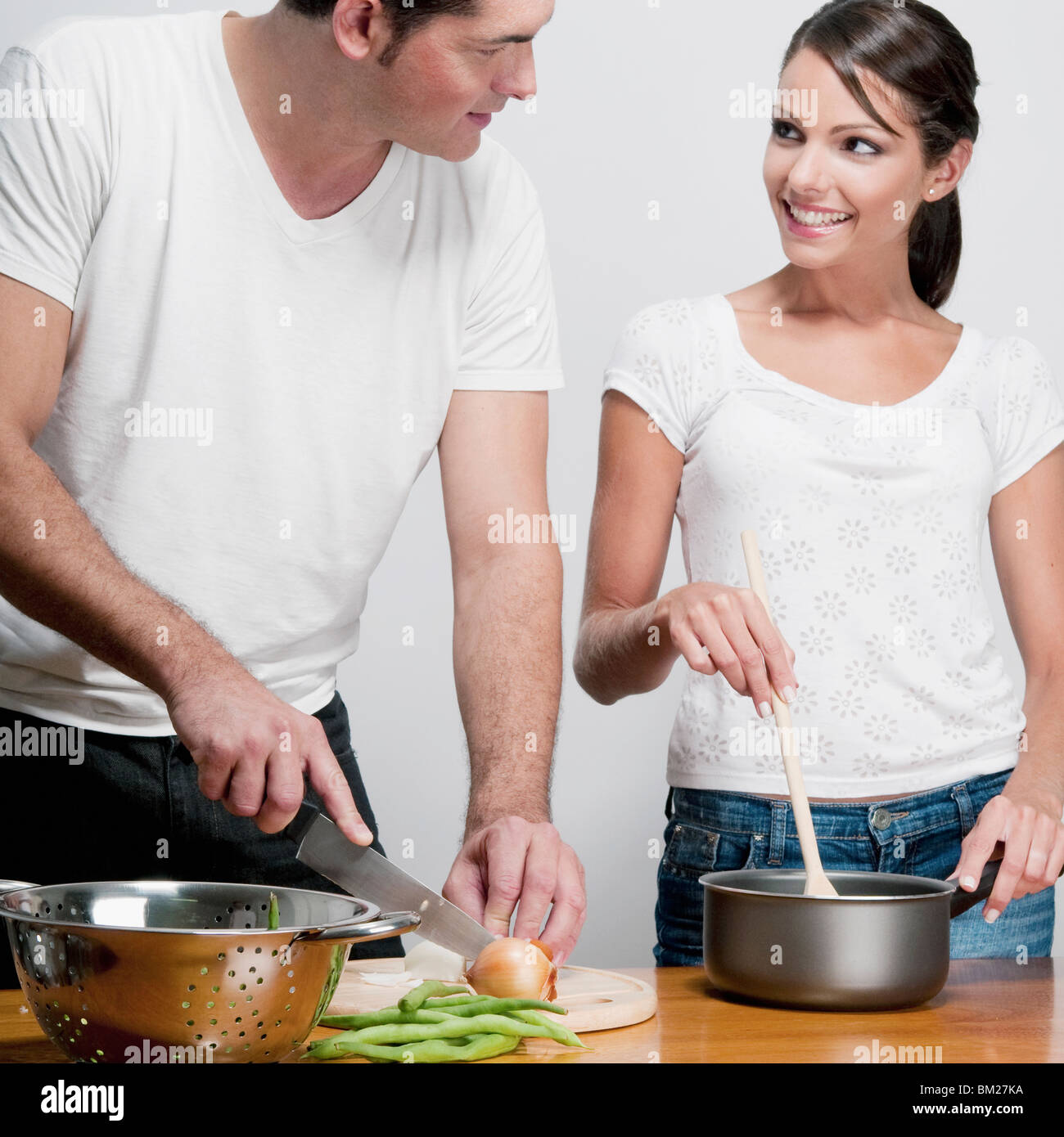 Couple cooking together Stock Photo - Alamy