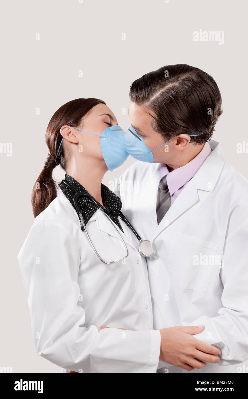 Doctors wearing flu masks and romancing Stock Photo - Alamy