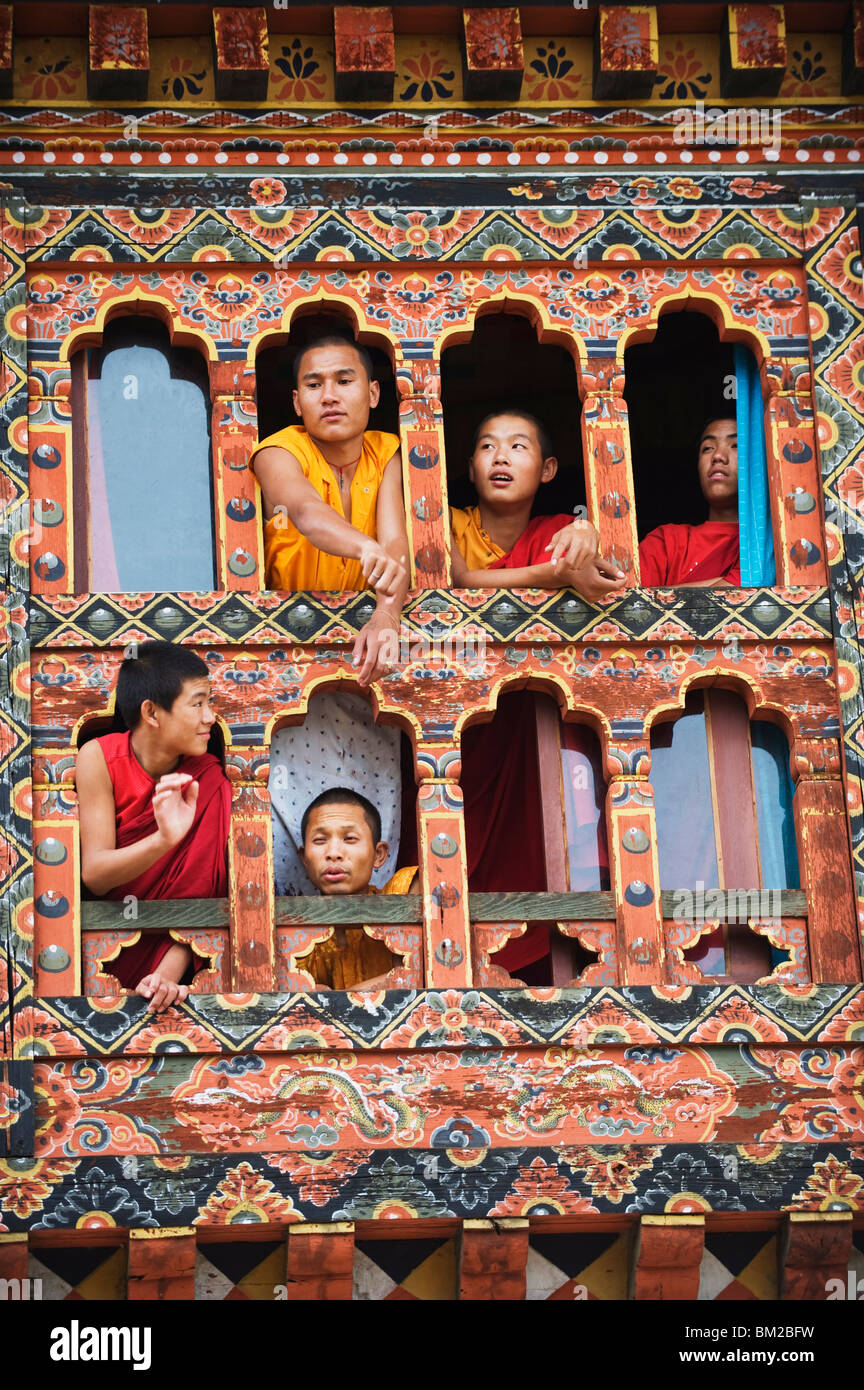 Young monks at a window, Chimi Lhakhang dating from 1499, Temple of the ...