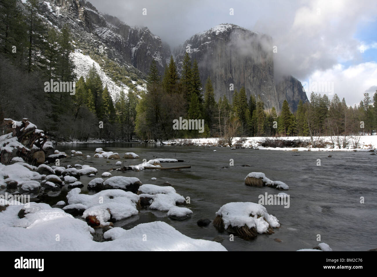 Snow lines the Merced River along with El Capitan and The Three ...