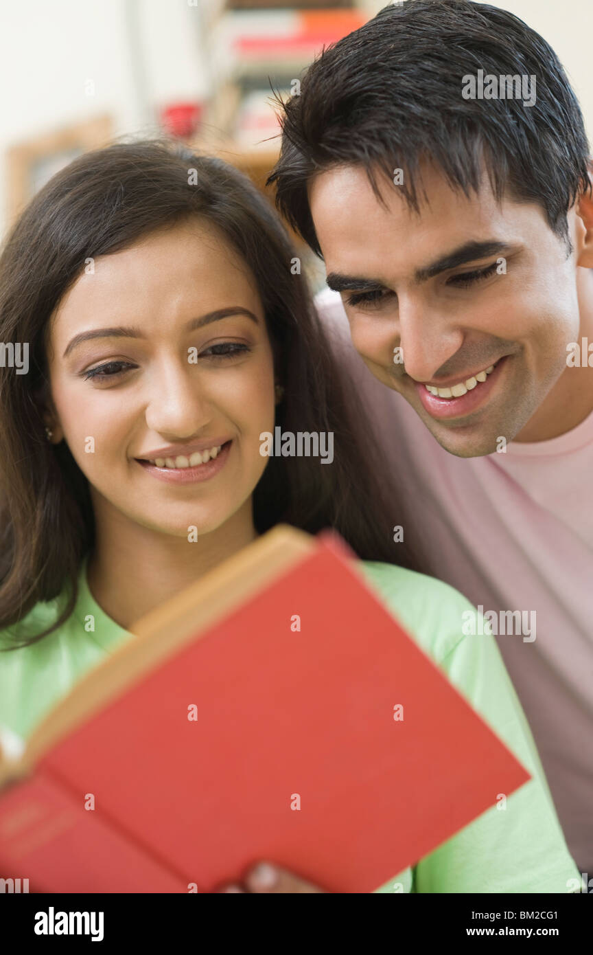 Couple reading book in the study room Stock Photo - Alamy
