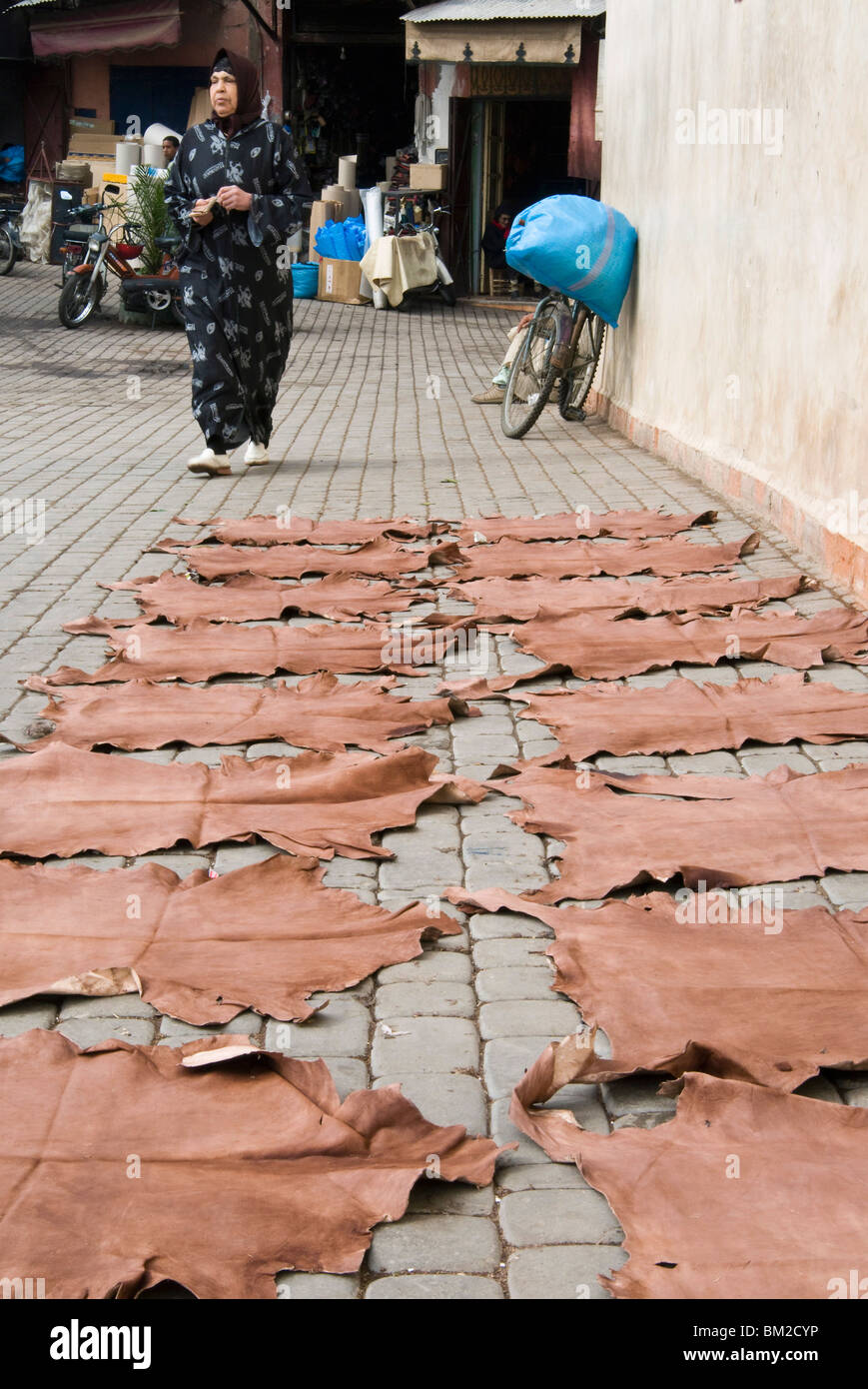 Dyed leather hides drying in street in the souk, Medina, Marrakech ...