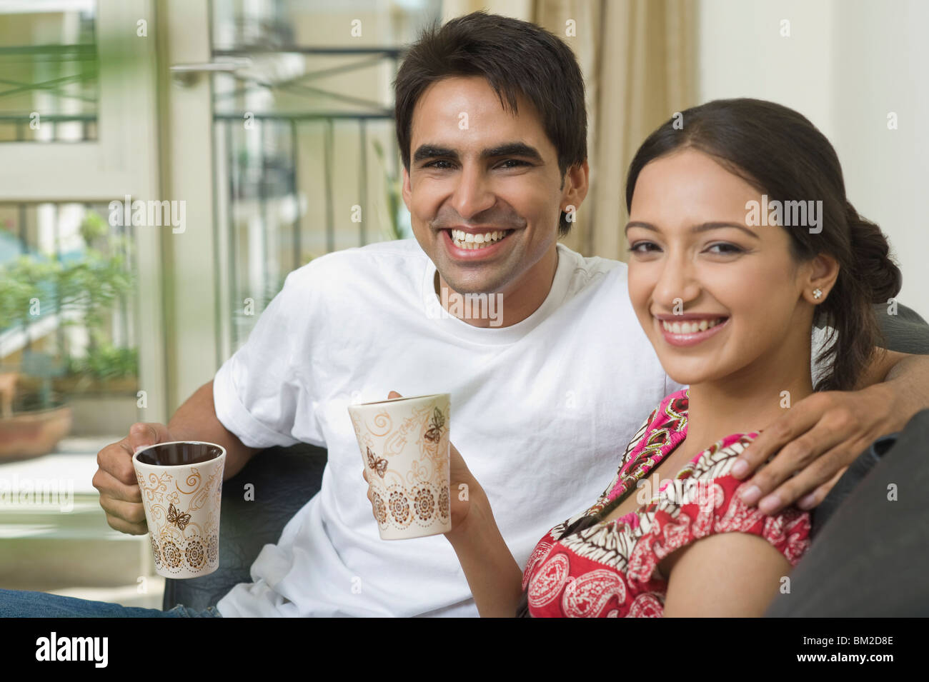 Portrait of a couple drinking coffee Stock Photo - Alamy