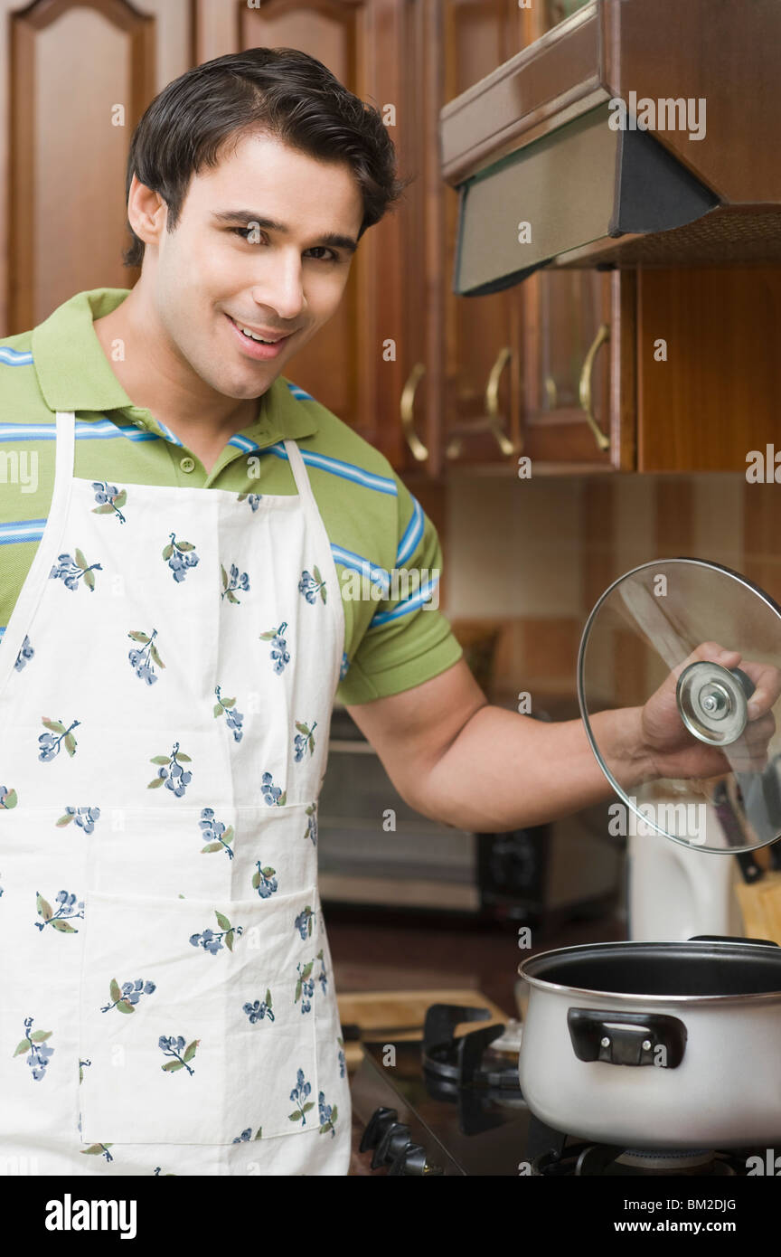 Man cooking food in the kitchen Stock Photo - Alamy