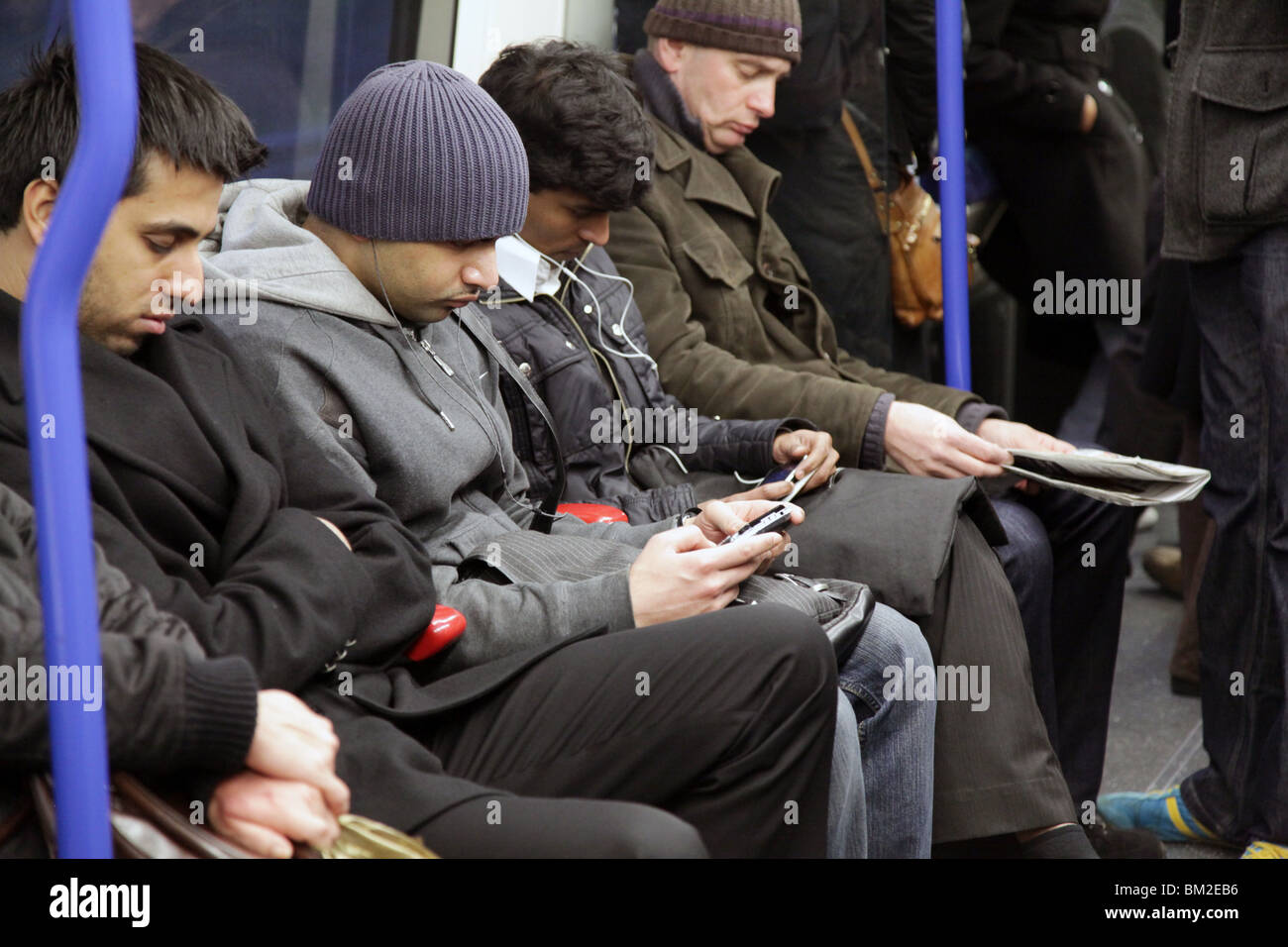 TEXTING ON OLD MOBILE PHONES, 2010: London underground tube commuter ...