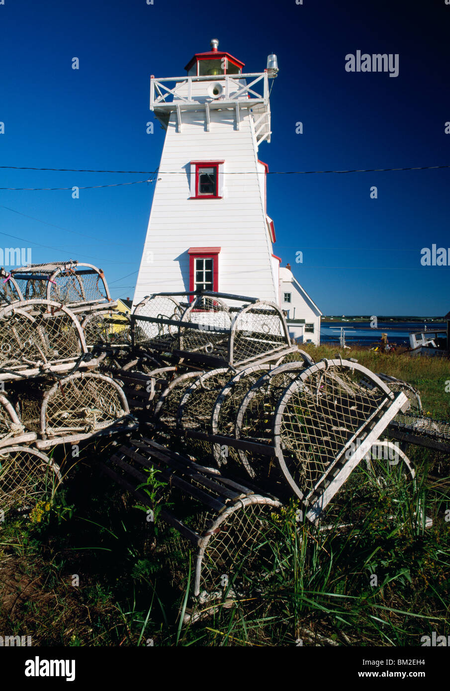 Lobster traps in front of a lighthouse, North Rustico Harbour ...