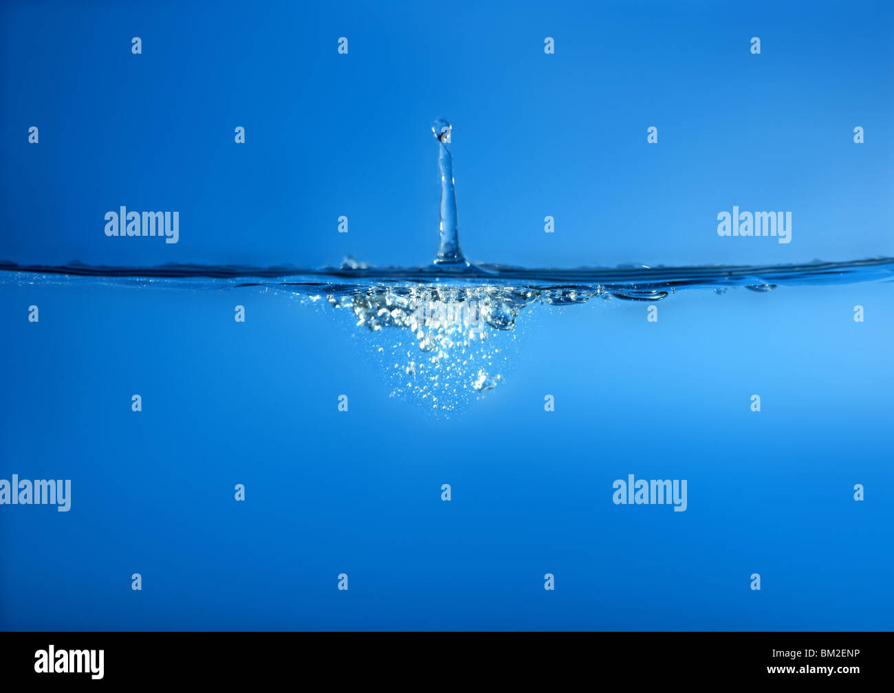 Splash on the blue water surface on side view Stock Photo - Alamy
