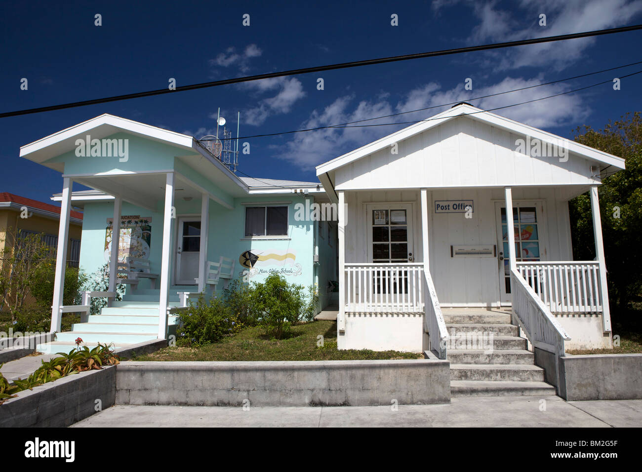 The quaint painted buildings of the Post Office and school on Man O War ...