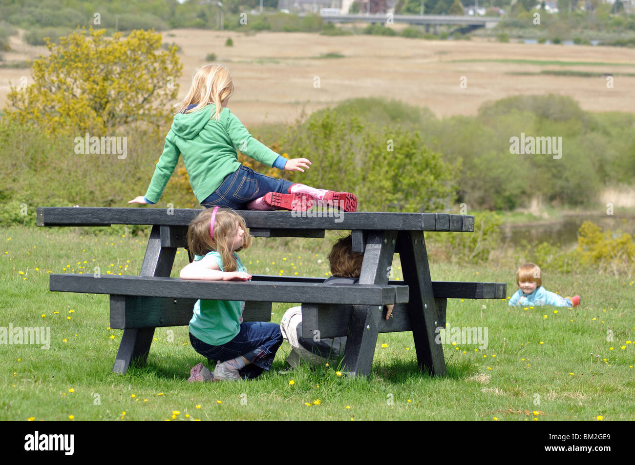 Children playing on pub picnic table, Cilgerran, Pembrokeshire, Wales ...