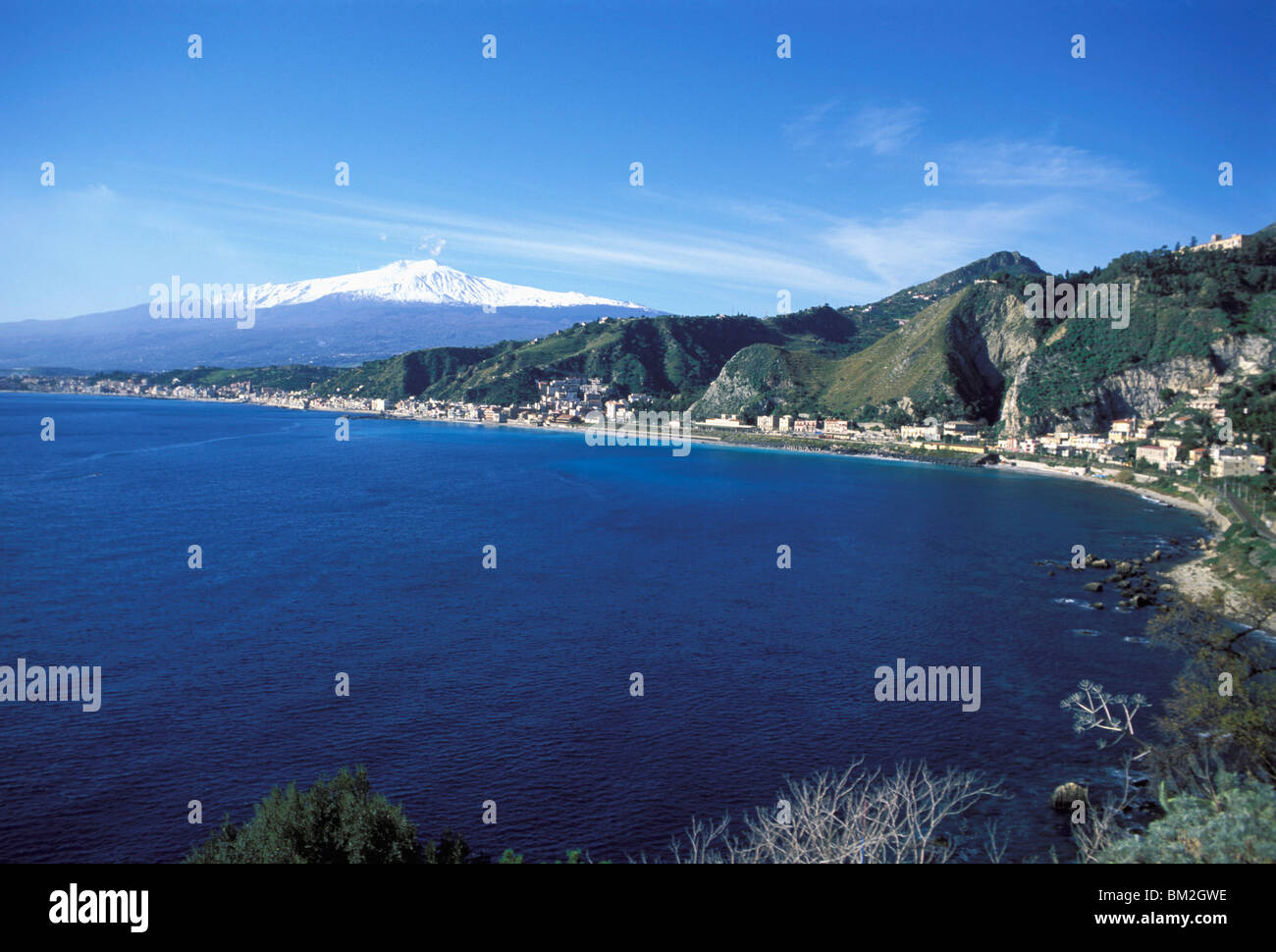 View of Taormina with Mount Etna in the background, Giardini Naxos ...