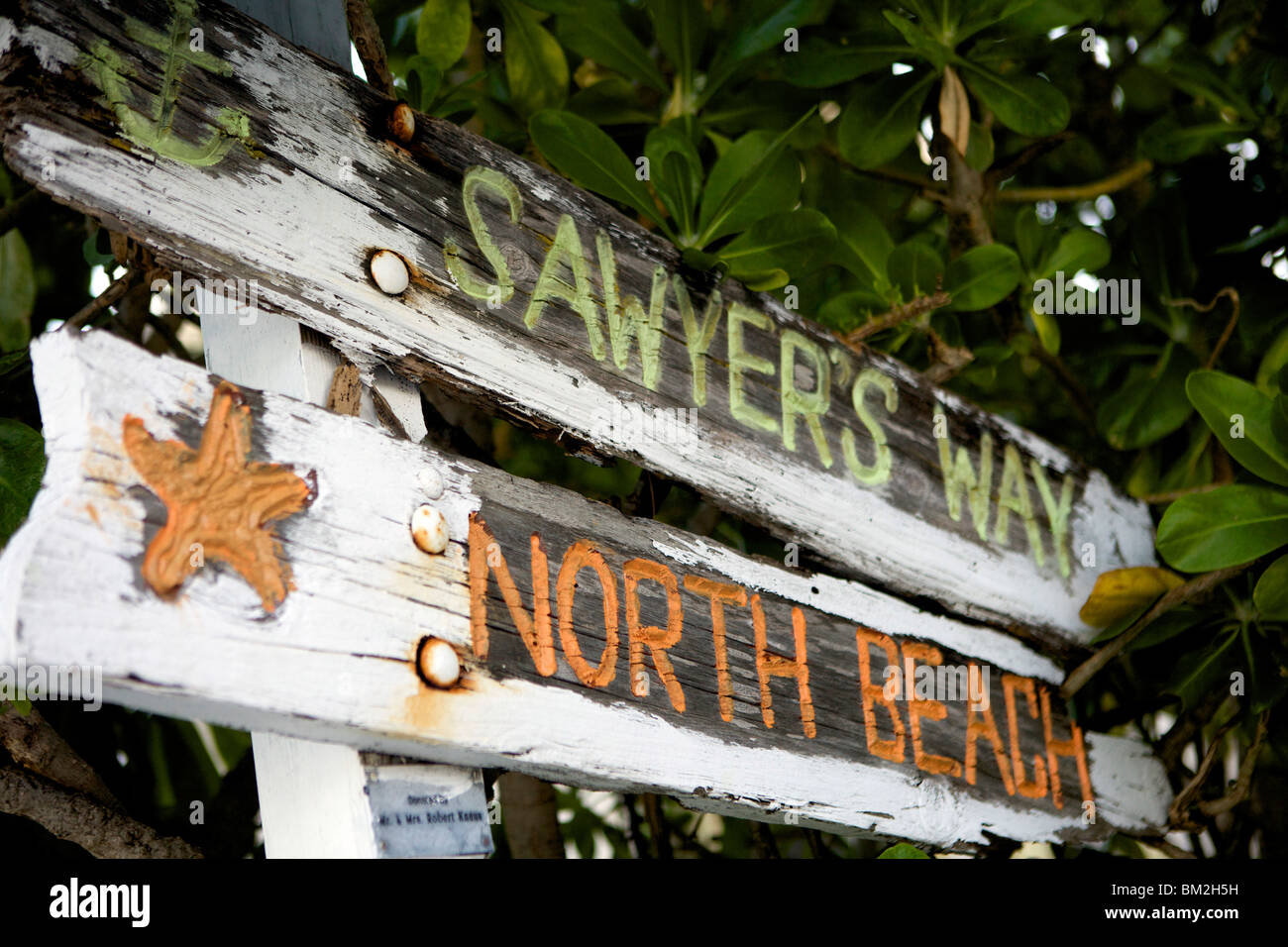 Quaint painted signs on wooden boards pointing the way to Sawyer's Way ...