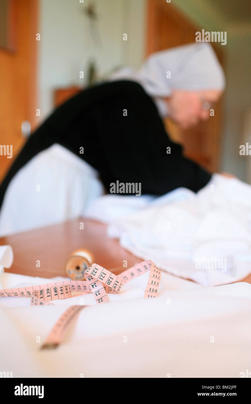 Benedictine nun making religious vestment, Urt, Pyrenees Atlantique ...