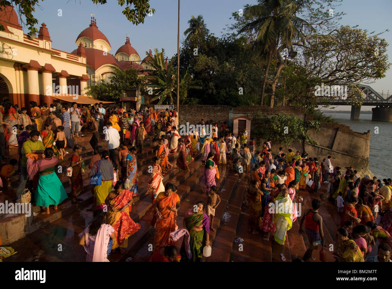 Pilgrims taking a ritual bath at a Kali temple on the river banks of ...