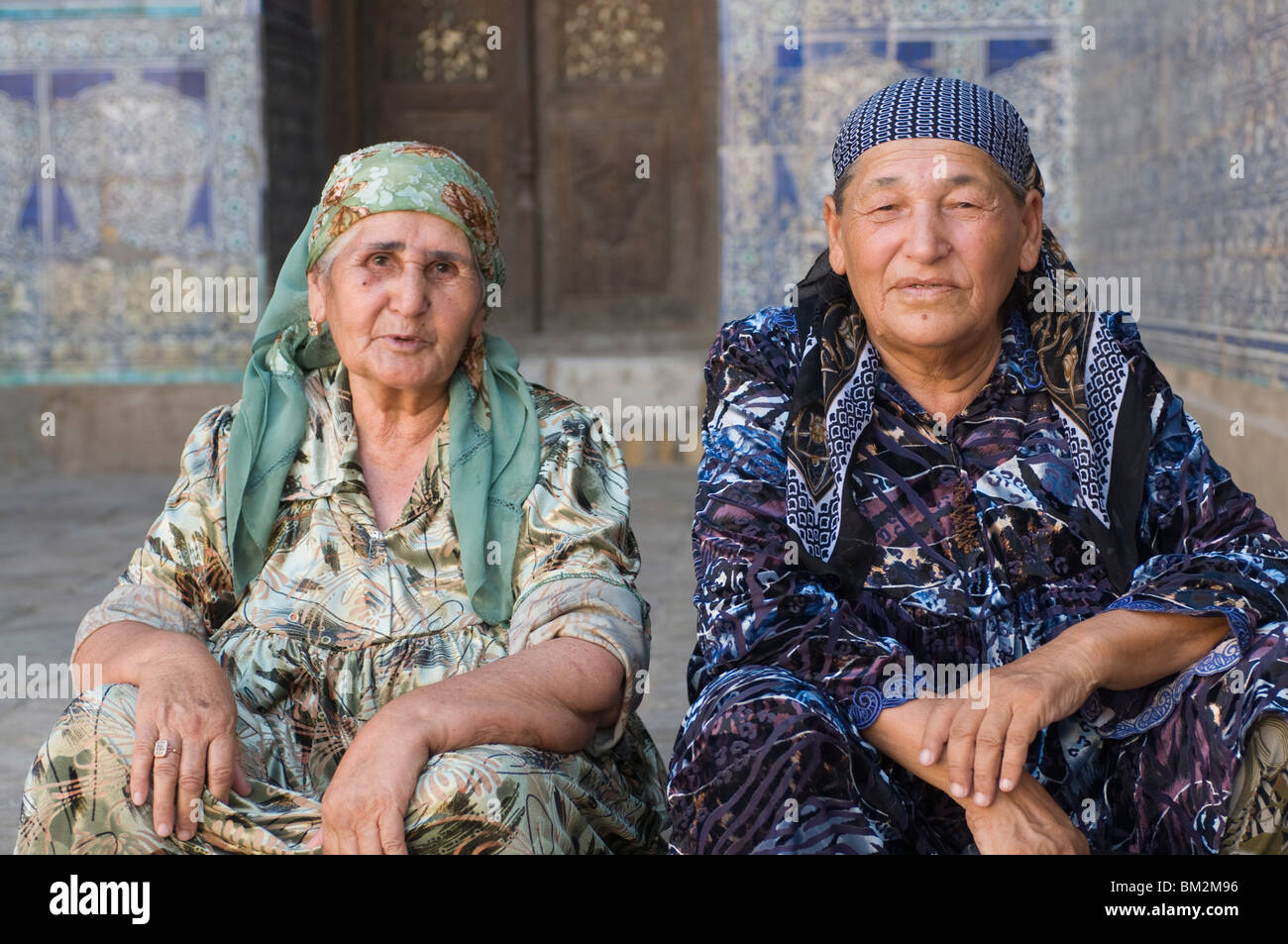 Old traditionally dressed women in the palaces of Khiva, Uzbekistan ...