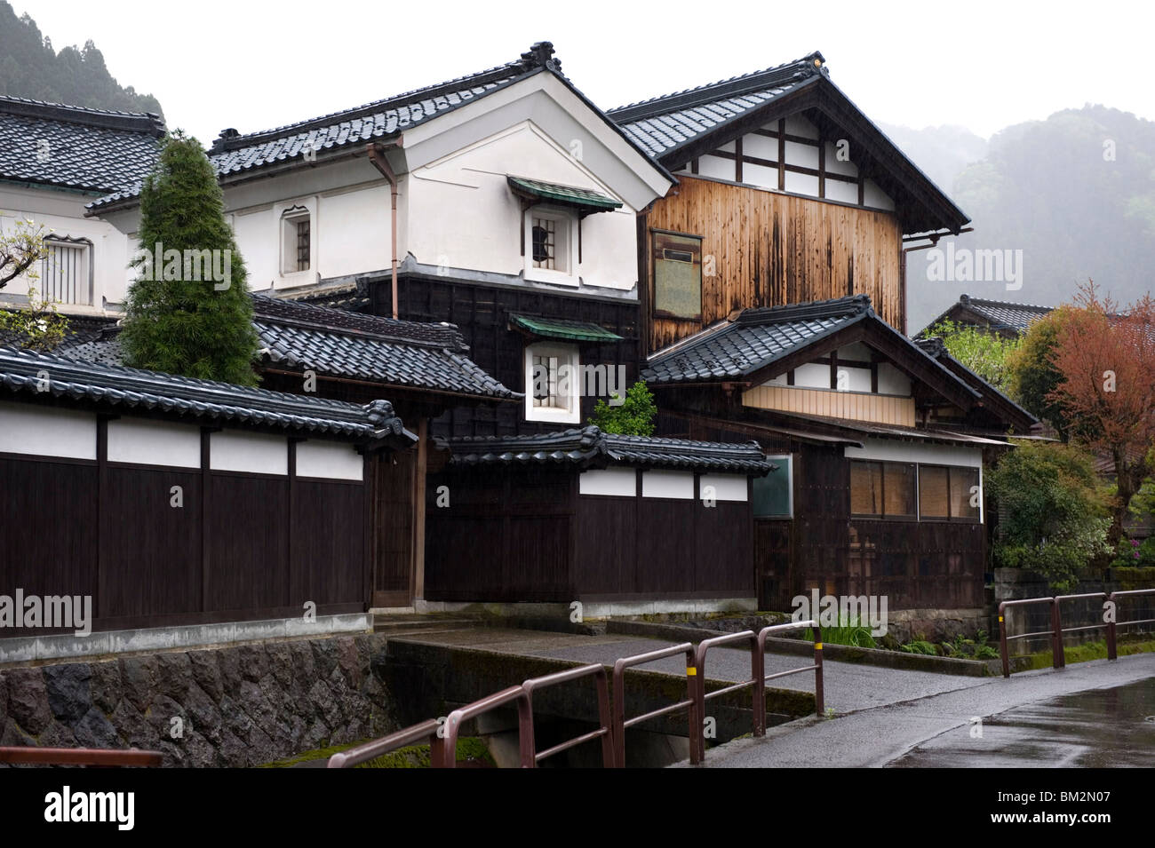 Traditional treasure warehouse (kura), beside single-family residence ...