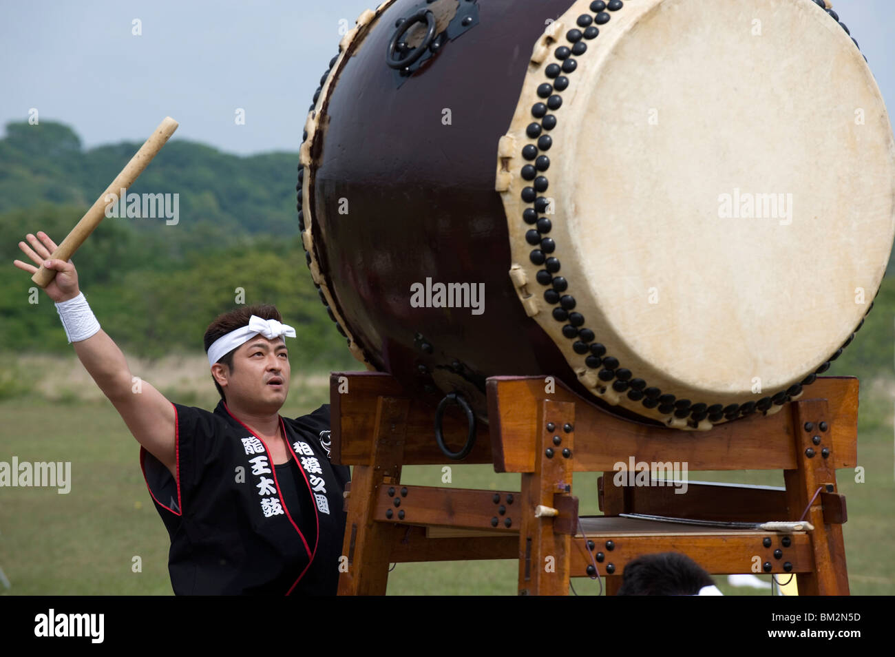 Drummer performing on a Japanese taiko drum at a festival in Kanagawa ...
