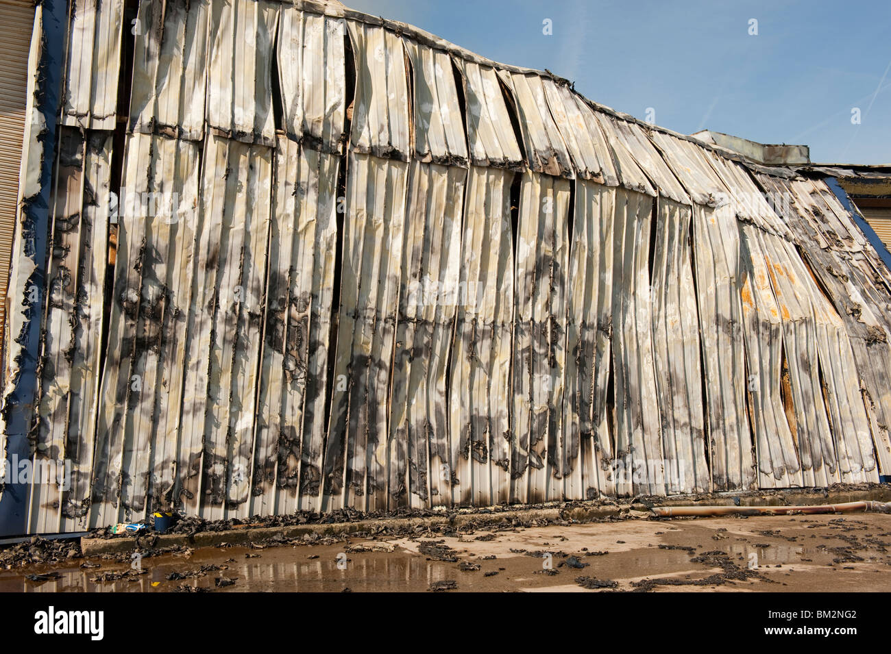 Large factory and warehouse collapsed and smoldering following major ...