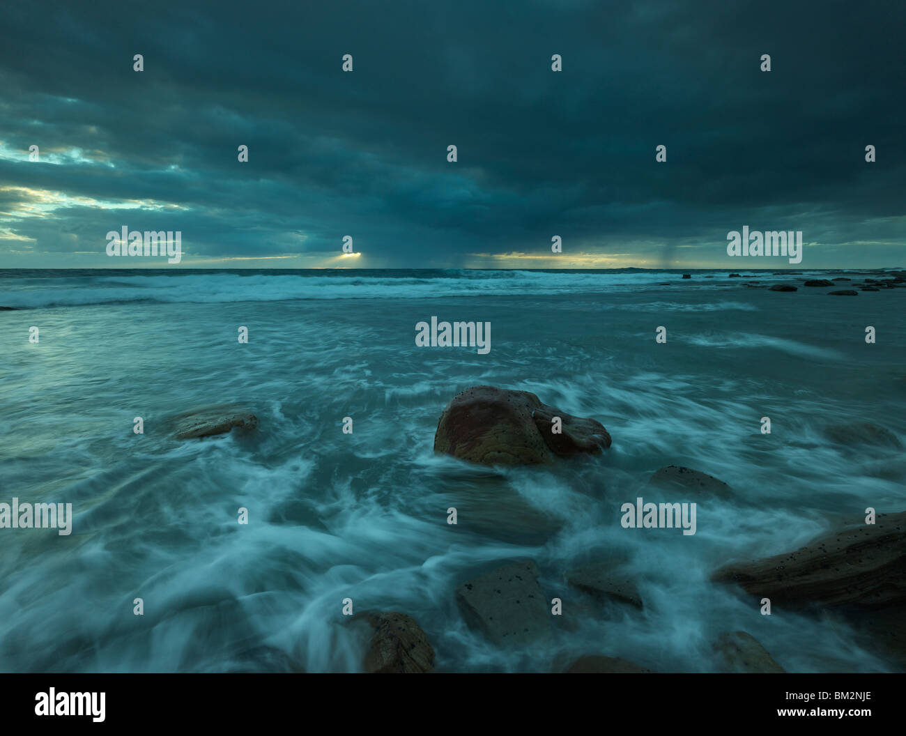 Rain shadows the rays of the rising sun, Coalcliff, NSW Australia Stock ...
