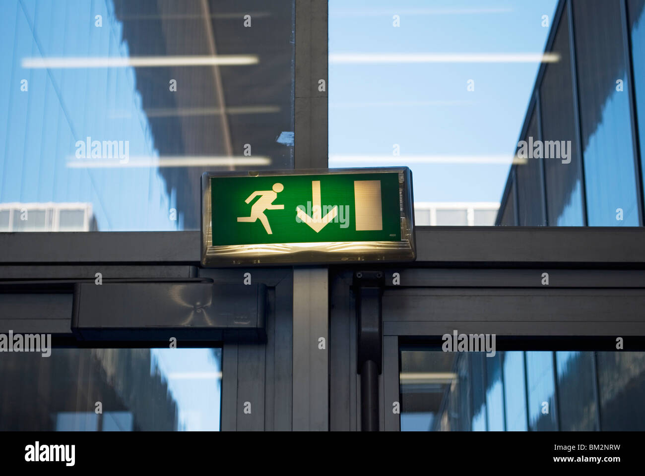 Running Man Emergency Exit sign on door Stock Photo - Alamy