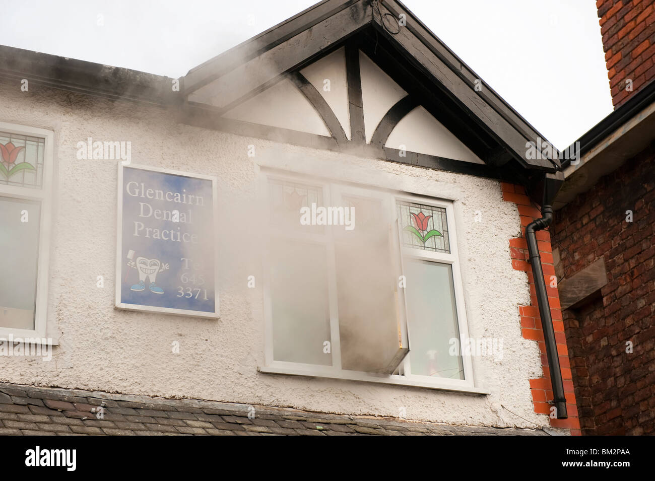 Smoke billowing from window Stock Photo - Alamy