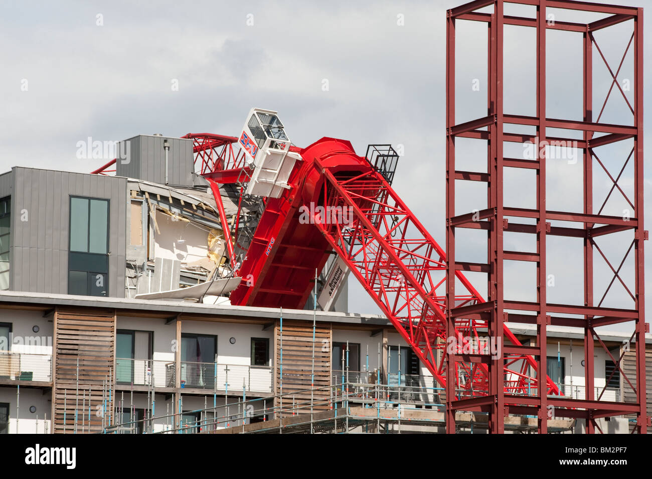 Tower crane fallen over onto roof at building site Stock Photo - Alamy