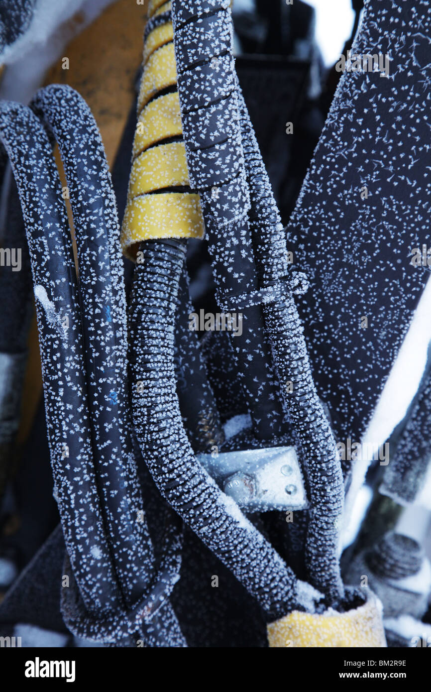 Detail close-up of ice covered frozen mechanical machine hydraulics ...