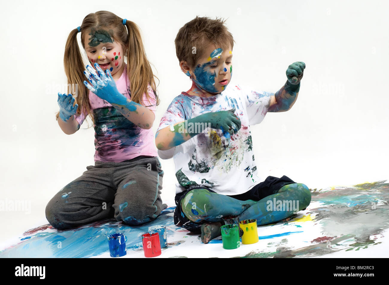 Kids having some fun with different color paints Stock Photo - Alamy