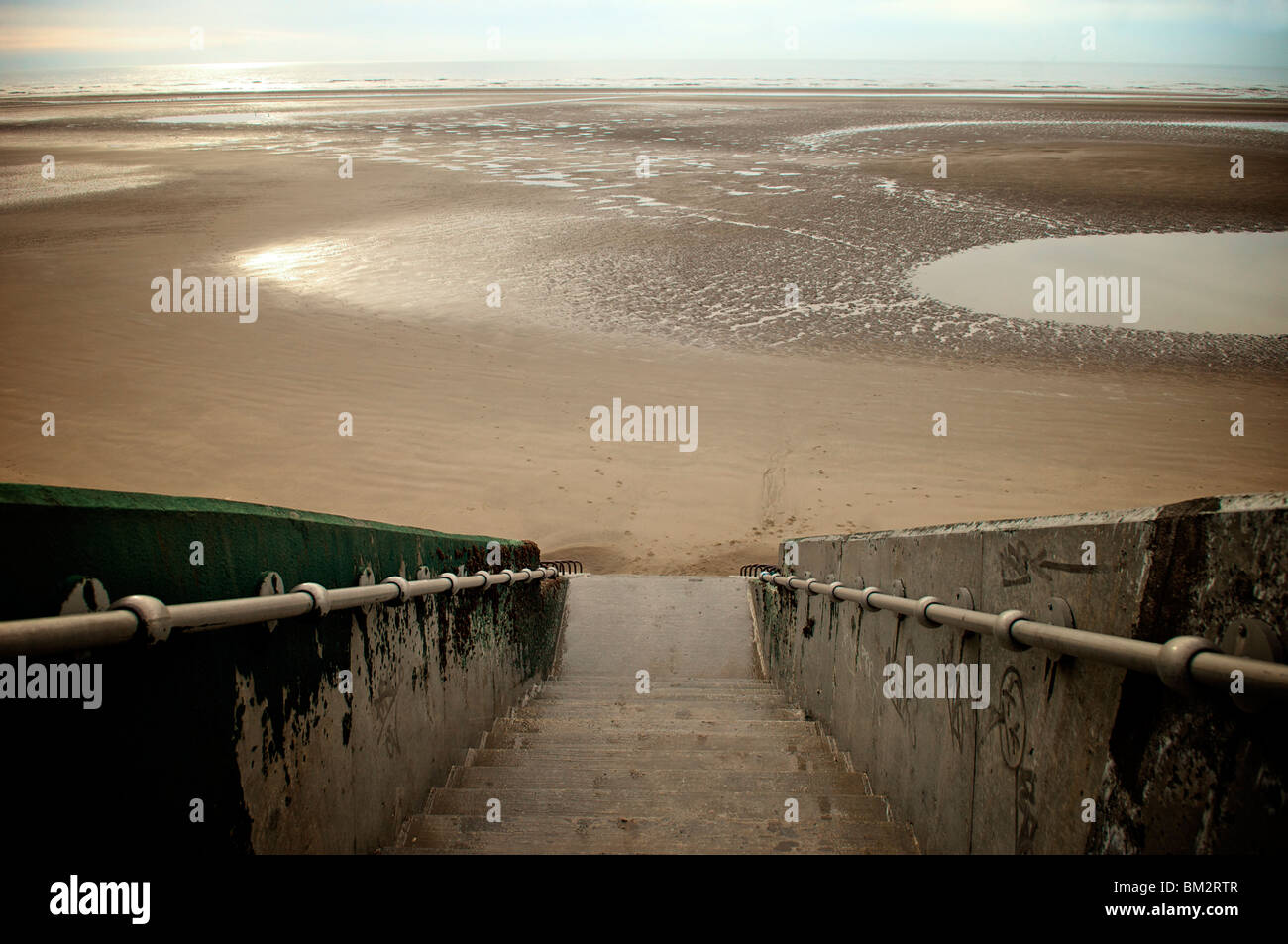 Steps down to empty beach at Blackpool Stock Photo - Alamy